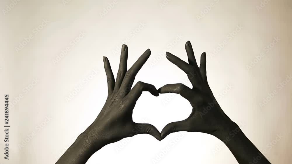 Black painted woman's hand doing heart symbol. Symbol of love ...