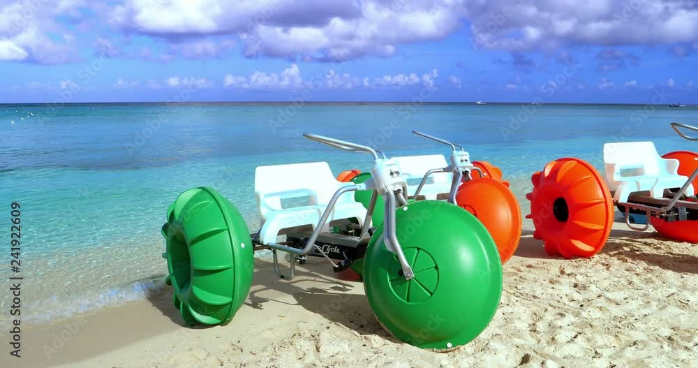 Colorful water bicycles on the tropical Caribbean ocean beach in ...