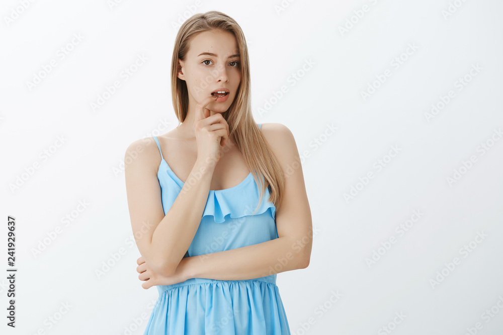 Silly good-looking european girl with fair hair and moles in blue dress ...