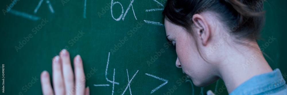 Teenager girl in math class overwhelmed by the math formula. Pressure ...