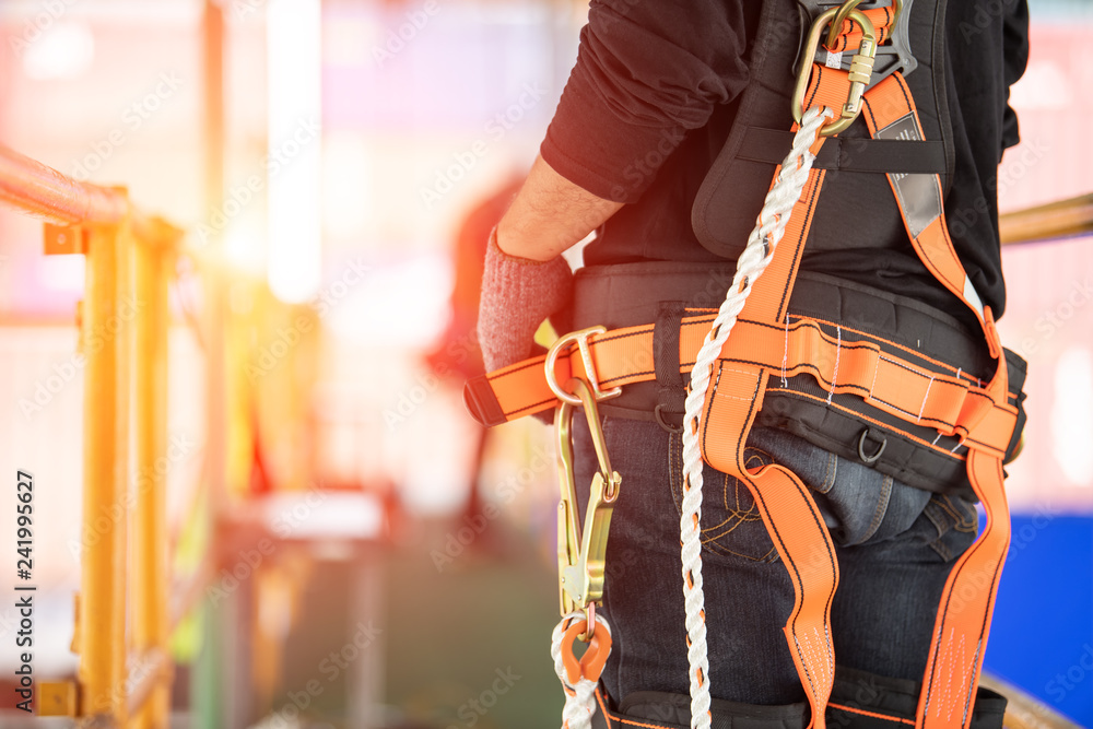 Construction worker use safety harness and safety line working on a new ...
