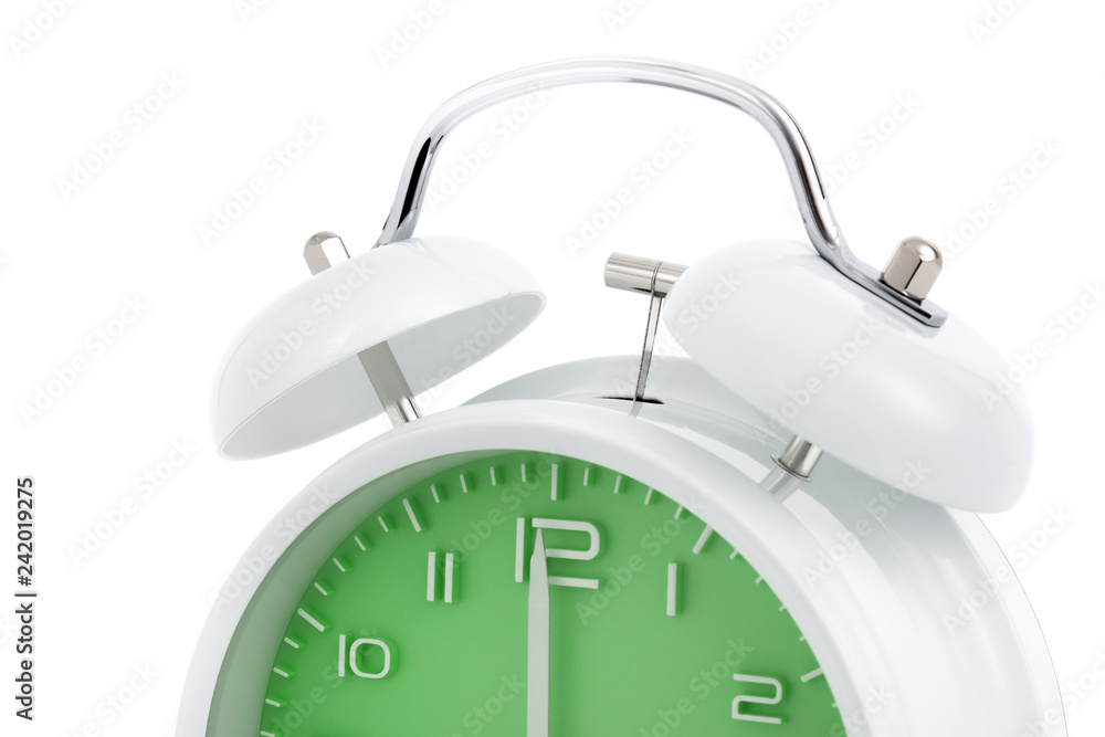 Cropped twin bells analogue alarm clock with green clock face shows ...