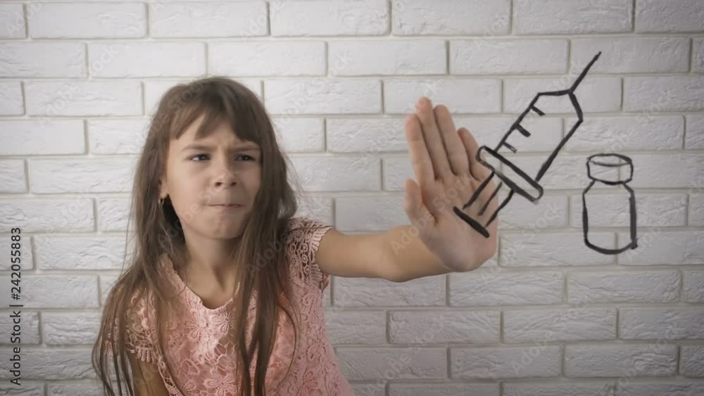 The child does not want to take medicine. No drug. Little girl shows ...