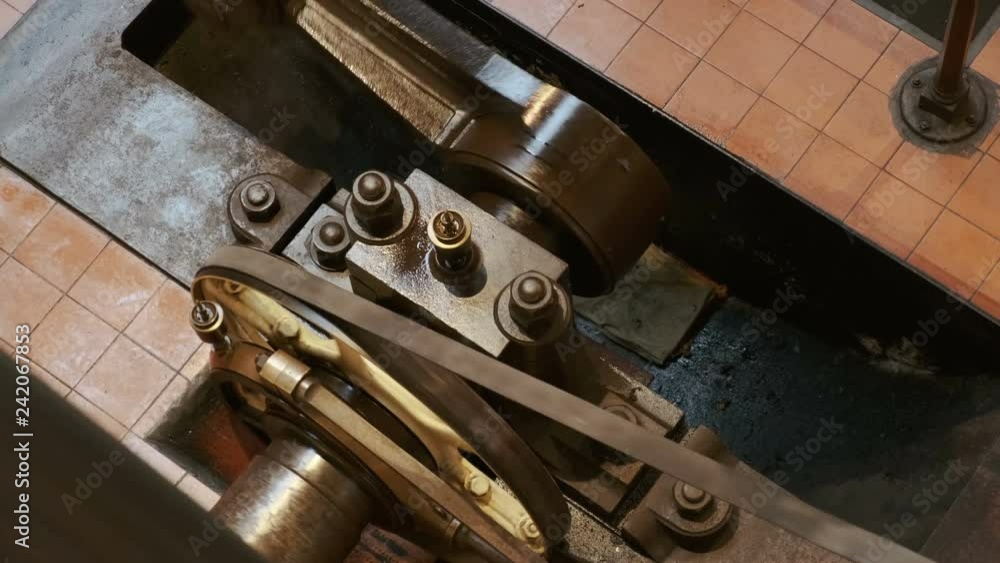 Close-up shot of a flywheel of a single cylinder industrial steam ...