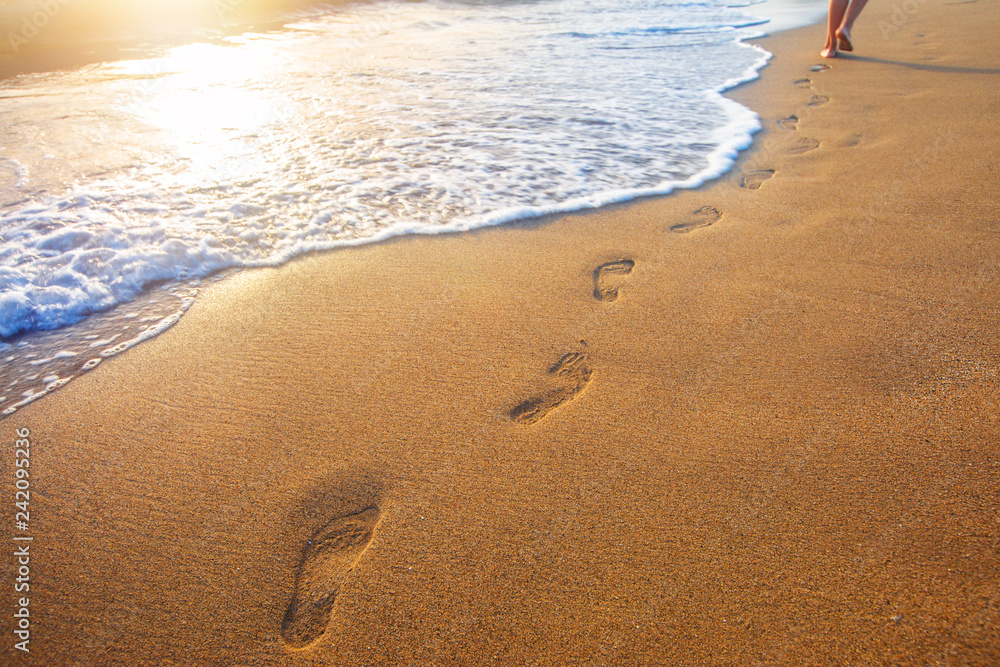 beach, wave and footprints at sunset time Stock Photo | Adobe Stock