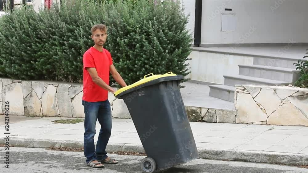 Family teamwork, father and son keep the street clean. Dad carries a ...