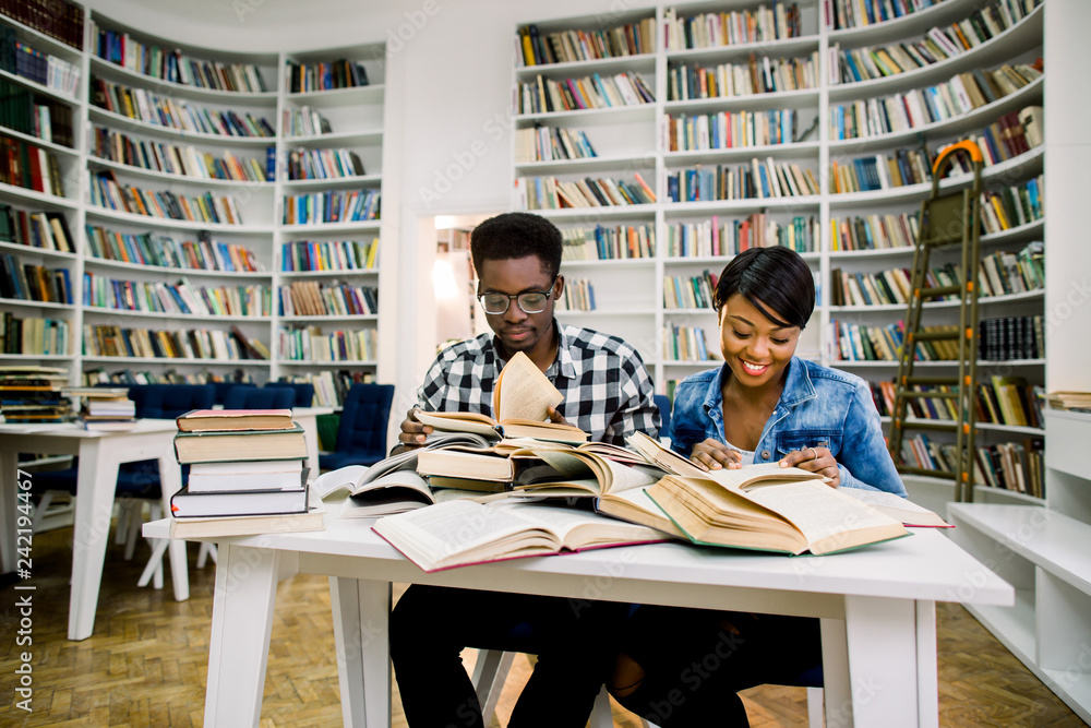 Cheerful african american students boy and girl sitting in university ...