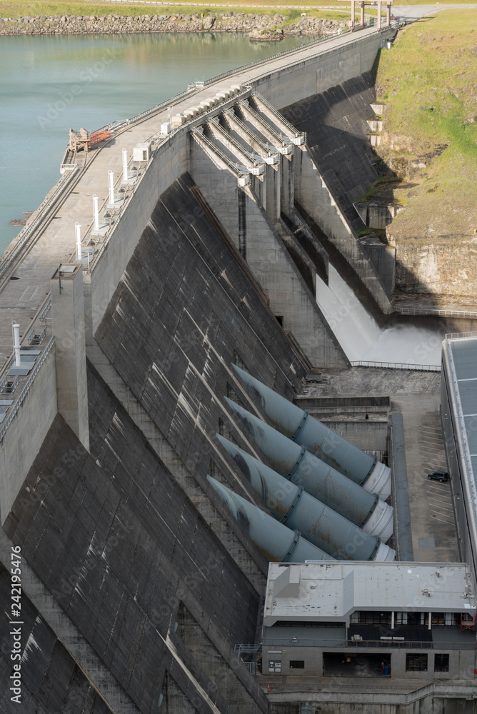 Side view of the Clyde hydroelectric power dam spilling large amounts ...