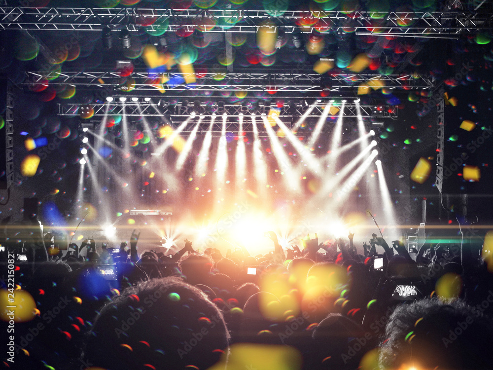 Concert crowd in front of a lit stage Stock Photo | Adobe Stock