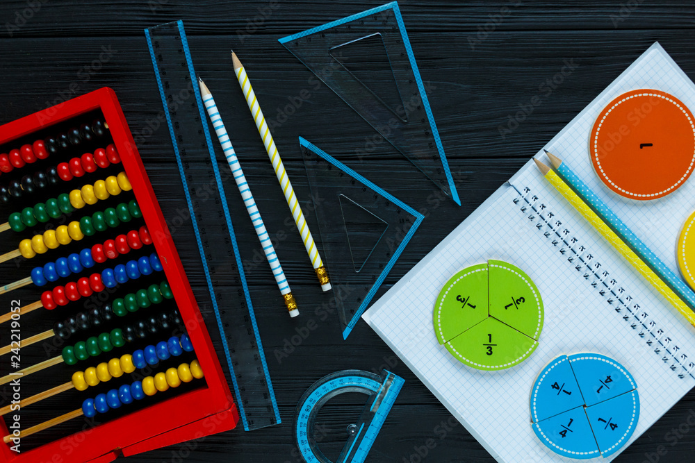 Colorful math fractions on dark wooden background or table. Interesting ...