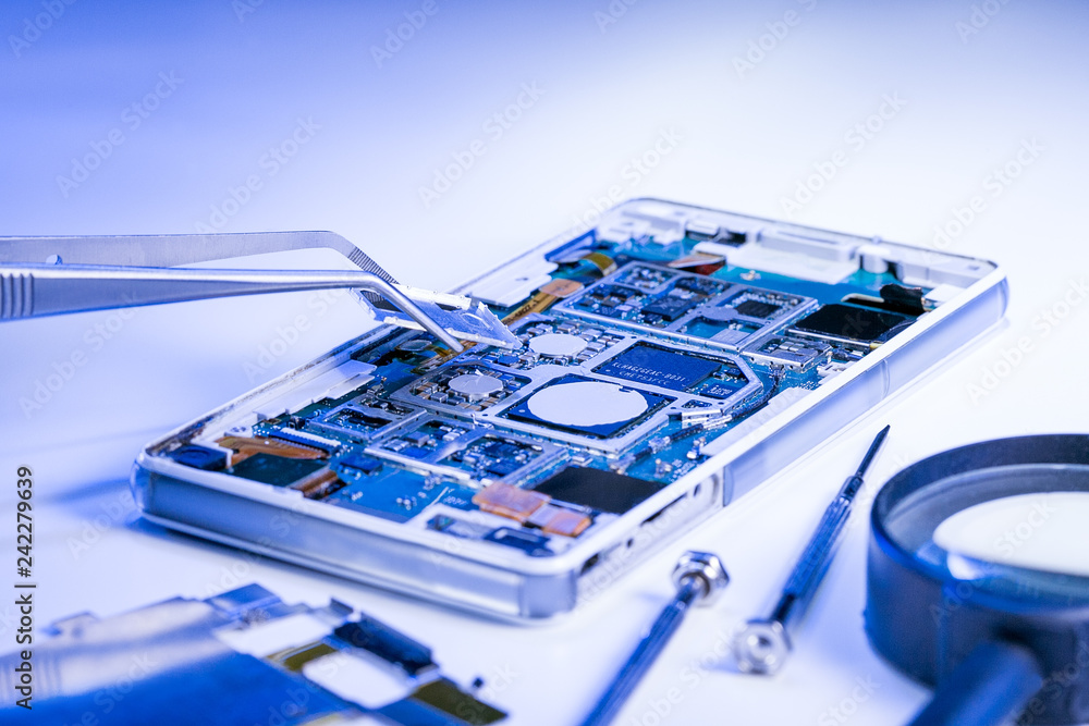 Repairing the smartphone's motherboard in the lab. the concept of ...