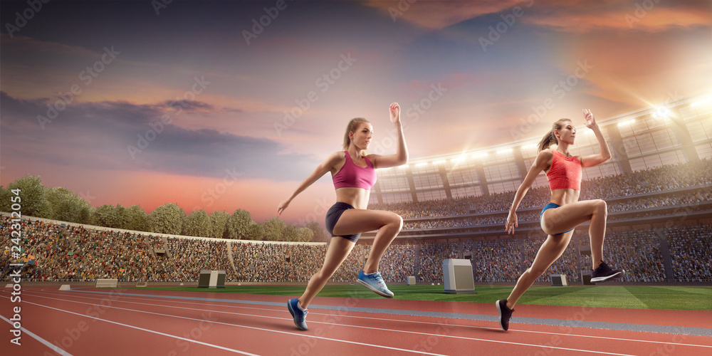 Female athletes sprinting. Two women in sport clothes run at the ...