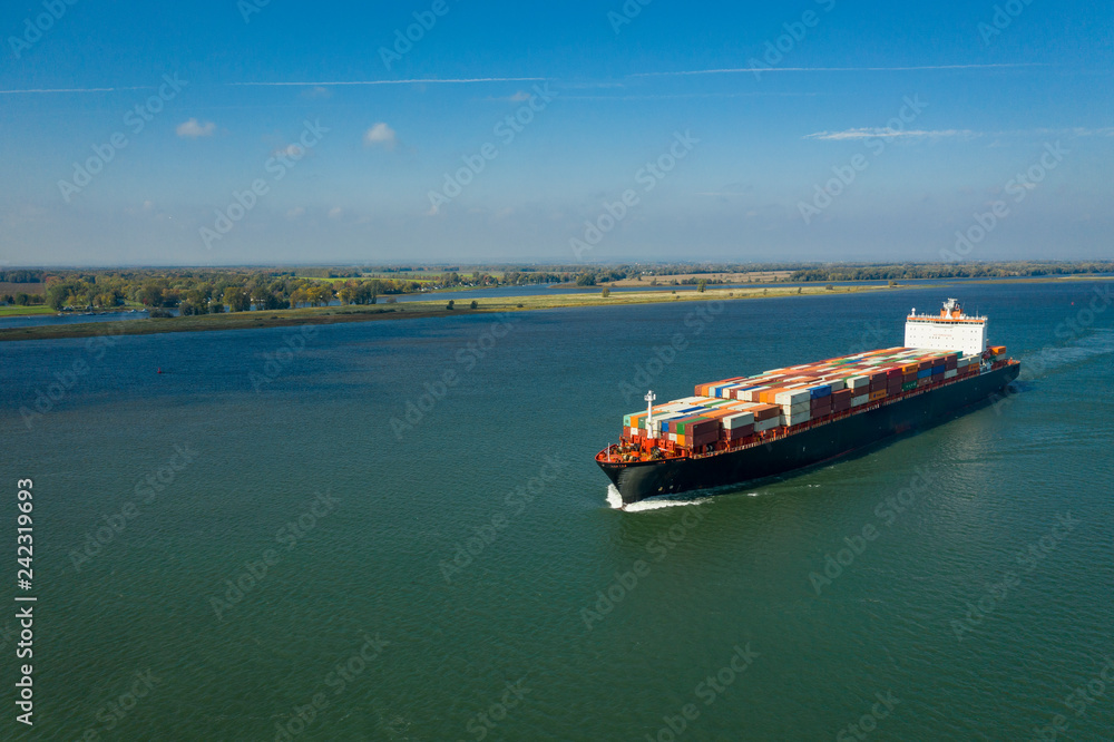 Foto de Aerial view of a container ship going upstream in the St ...