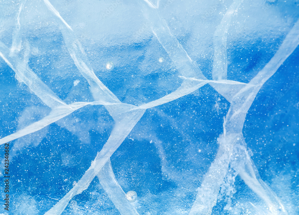 Abstract ice background. Blue background with cracks on the ice surface ...