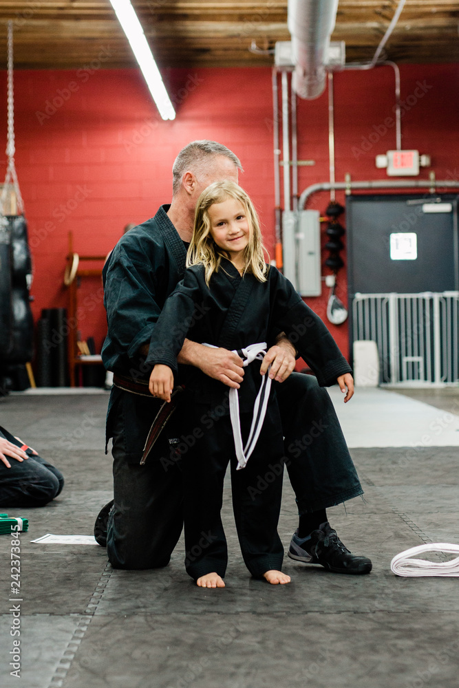 Little Girl Receiving Belt in Martial Arts Class Stock Photo | Adobe Stock