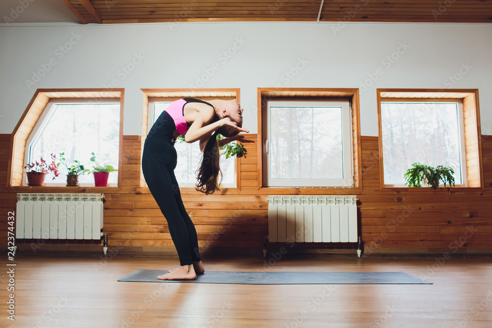 yoga, standing in variation of head to knees exercise, uttanasana pose ...