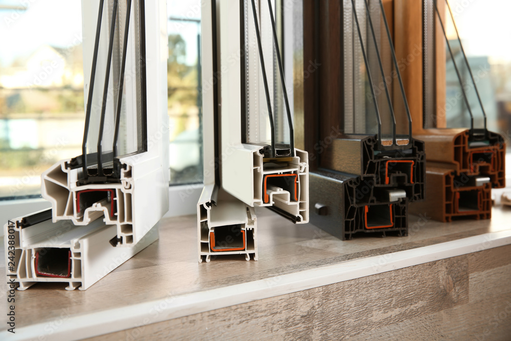 Samples of modern window profiles on sill indoors, closeup ...