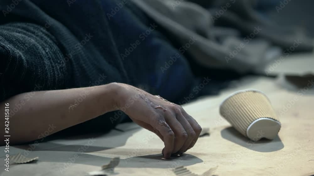 Homeless person with skin disease sleeping on dirty street, cold night ...