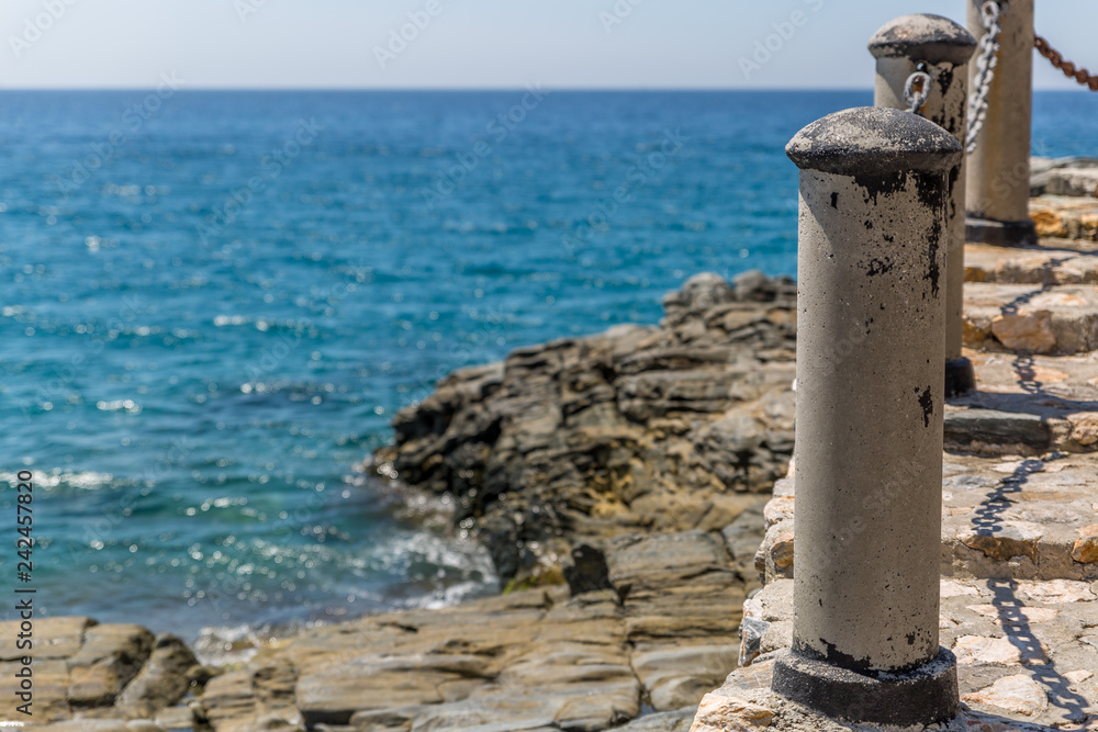Metal bollards and chains to make a barrier in a coastal area of ...