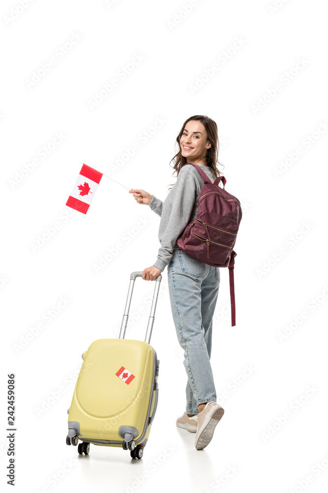 female student with suitcase and canadian flag looking at camera ...