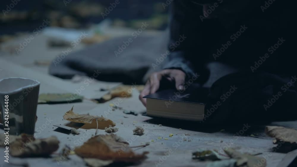 Homeless refugee praying and kissing bible, hope for better life ...