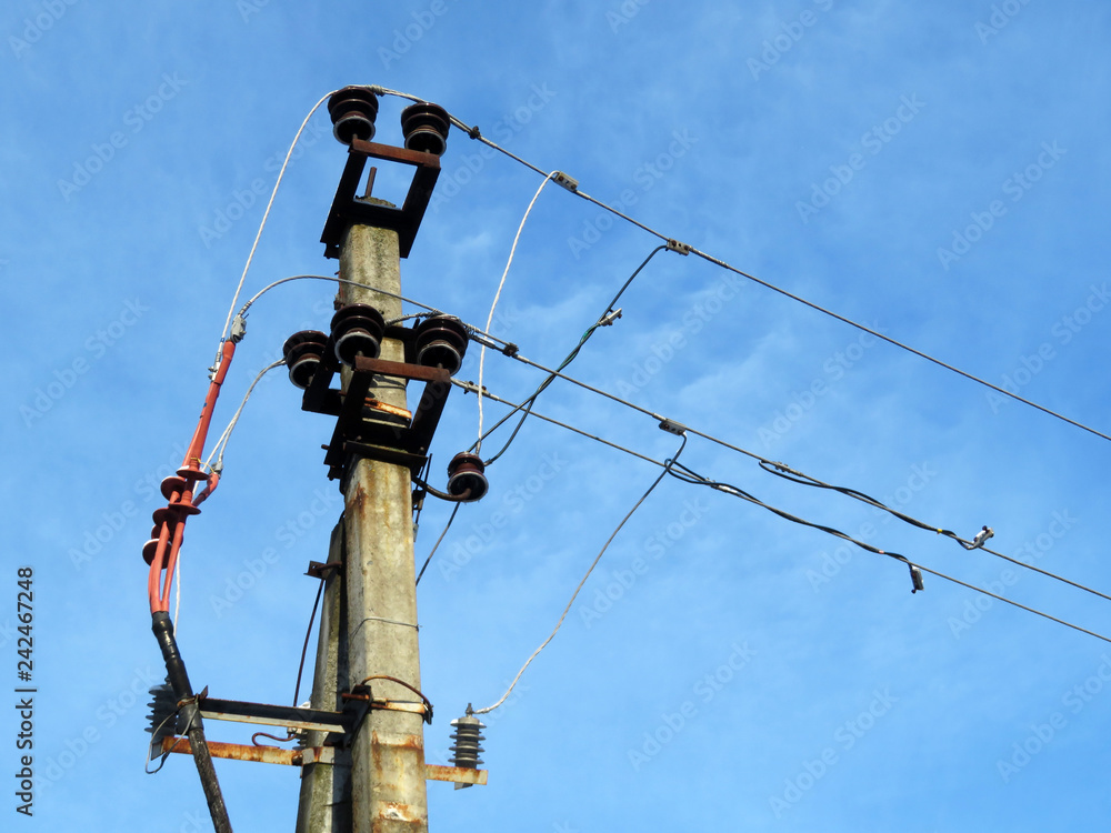 Power line post with electrical wires and capacitors isolated on blue ...