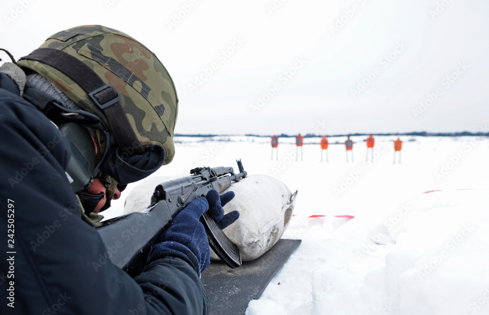 Soldier aiming on marks with Kalashnikov rifle Stock Photo | Adobe Stock