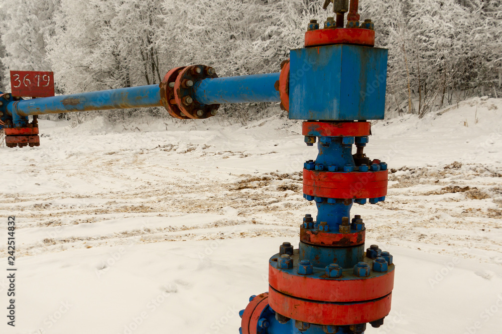 Horizontal view of a wellhead with valve armature. Oil and gas industry ...