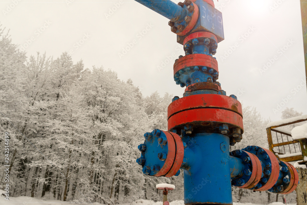 Horizontal view of a wellhead with valve armature. Oil and gas industry ...