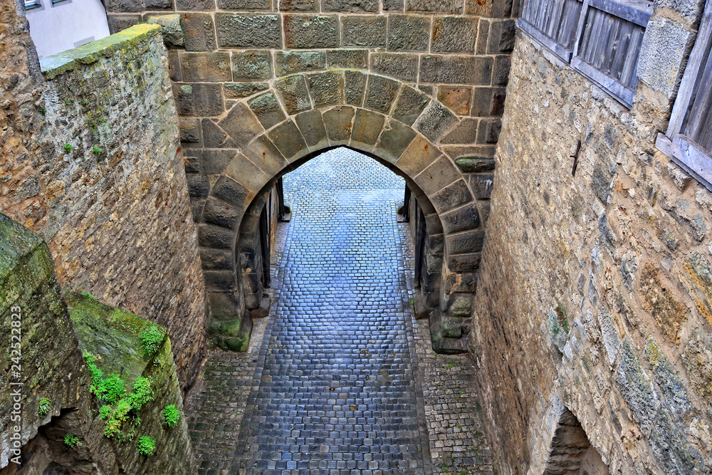 Ancient gate to a medieval city. Stone fortress. Cobblestone road. Top ...