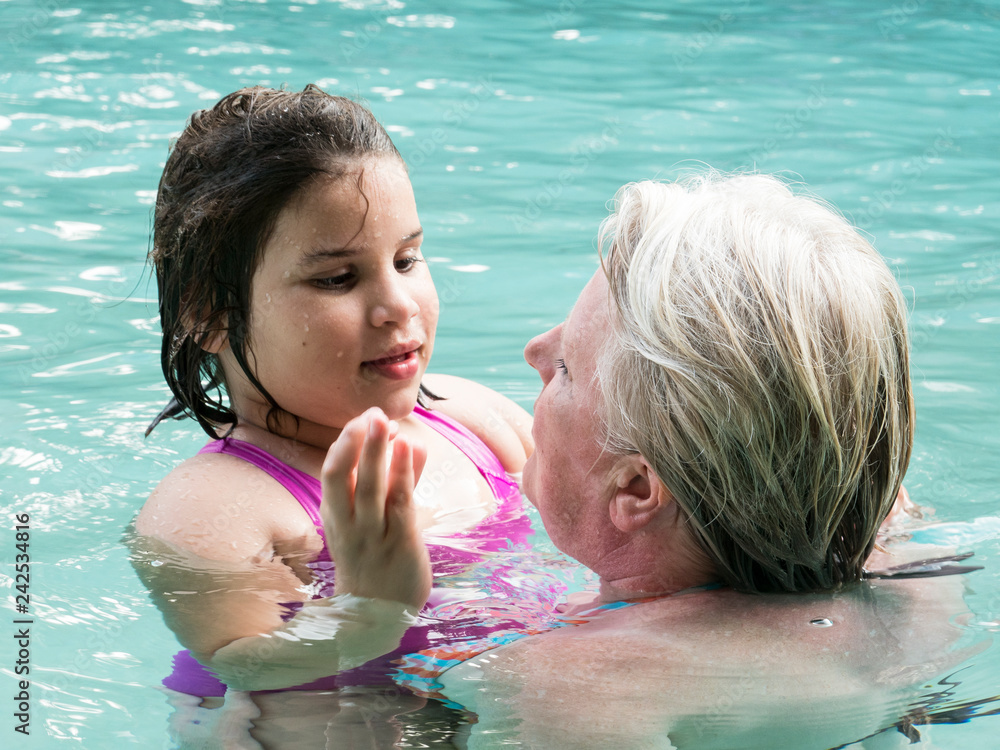Happy family in swimsuits in swimming pool at water park resort Stock ...