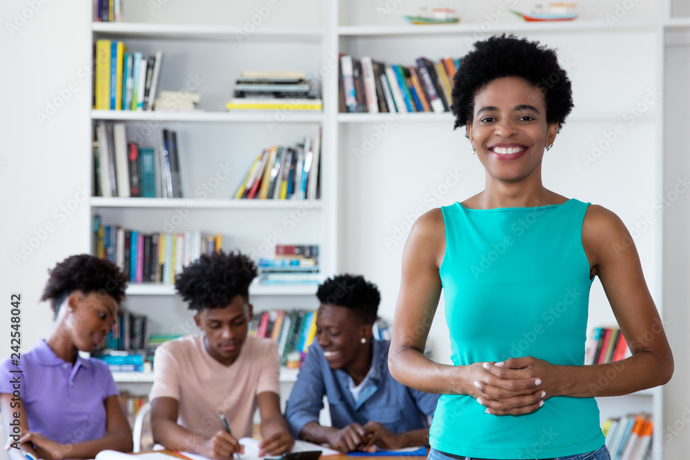Laughing african female teacher with class at school Stock Photo ...