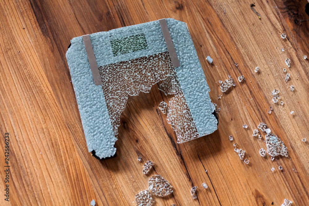 Broken digital human scale on the floor. Broken glassy digital scale ...