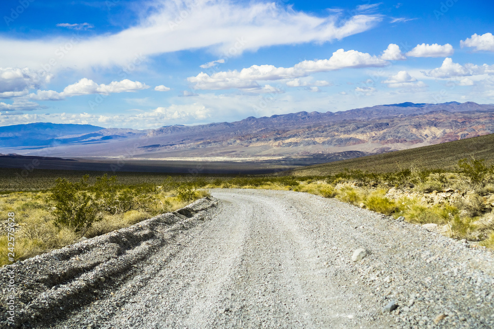 Travelling on an unpaved road through a remote area of Death Valley ...
