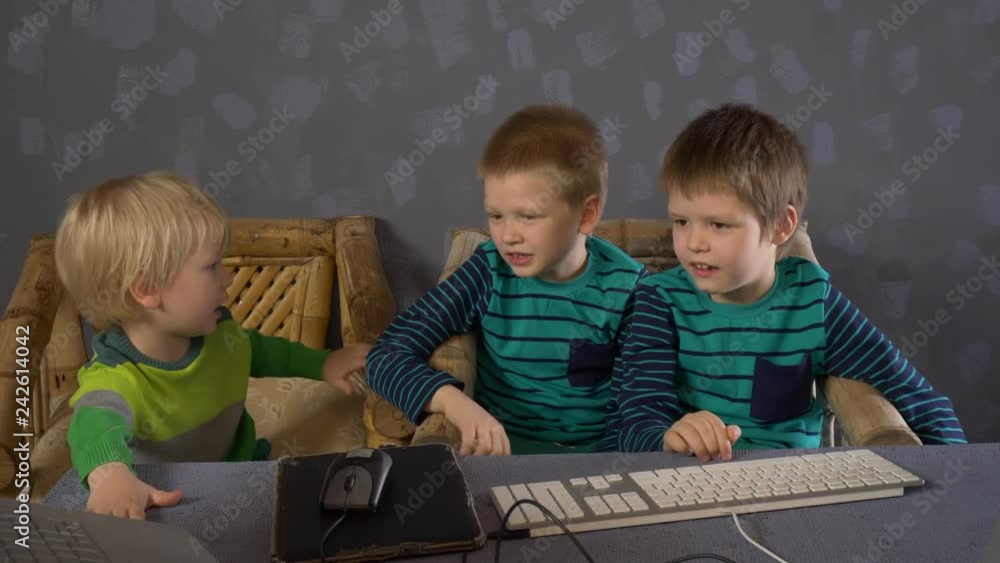 Funny kids watch educational program on computer and learn to read and ...