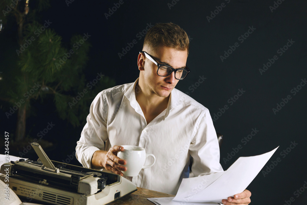 Handsome writer man wearing glasses and white shirt sitting at the ...