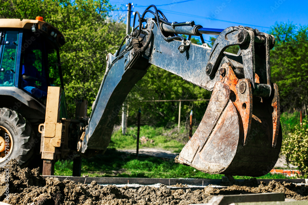 Excavator used for pipe laying works and house foundation. Digging a ...