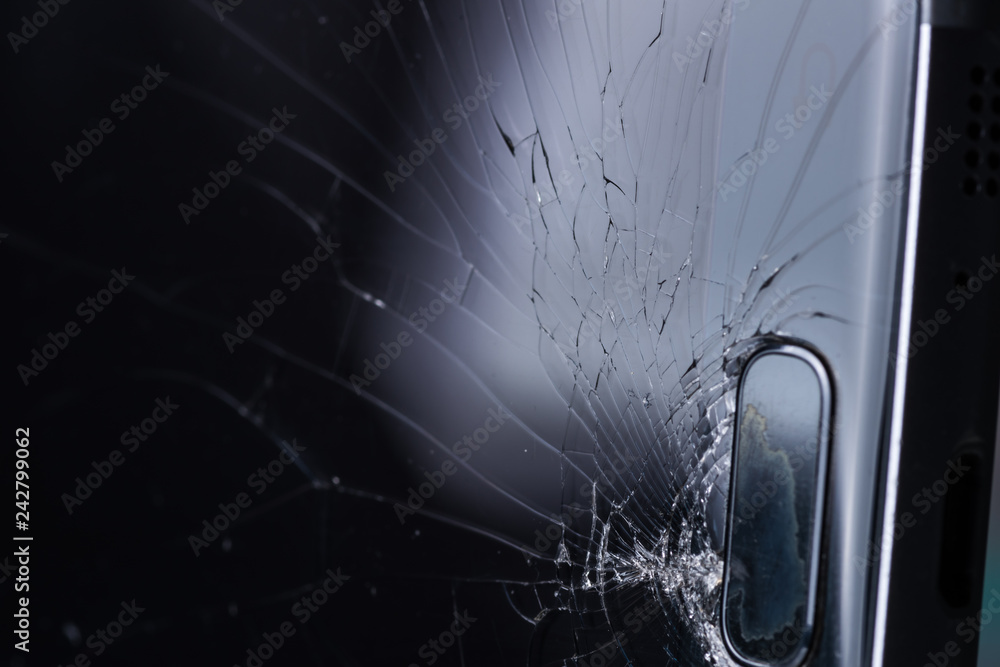 Broken smartphone screen, cracks and shattered glass under various eels ...