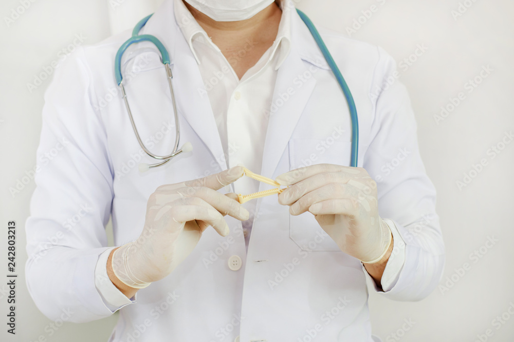 Doctor holding yellow umbilical cord clamp used to clamp off the ...
