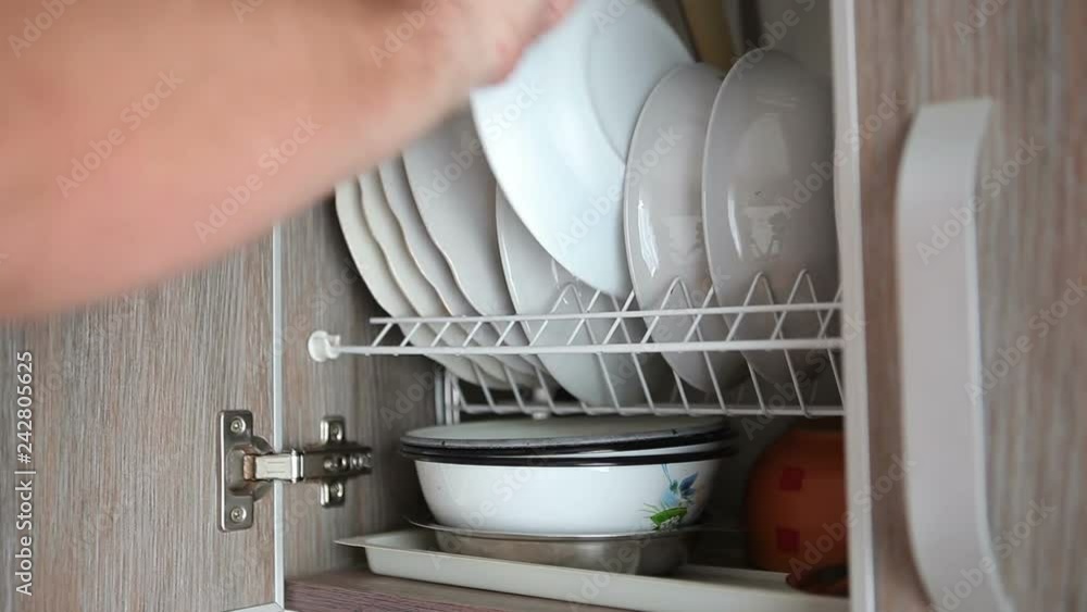 The man opens the door and picks up the plate. The plates for the first ...