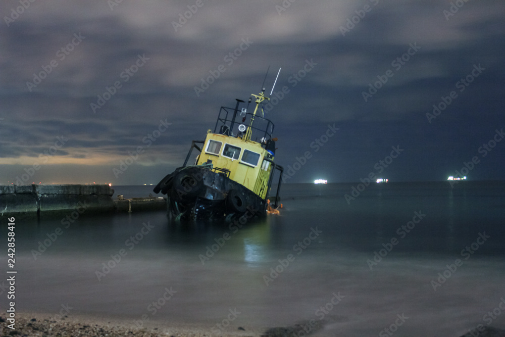 Tugboat ran aground, starry night sky with clouds. Long exposure Stock ...