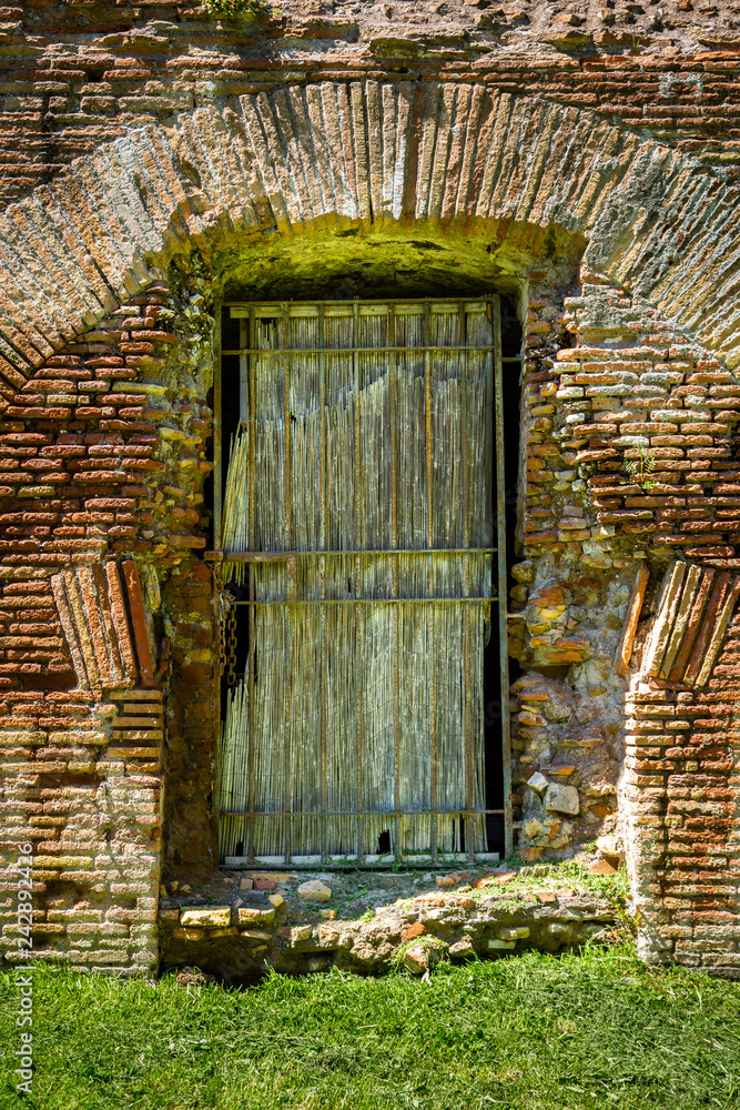 Outdoor front view of one old ancient weathered wooden entrance door ...