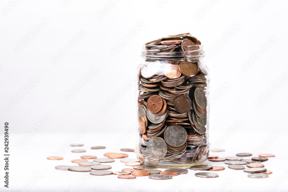 Money spilling over jar on a white background, saving money Stock Photo ...