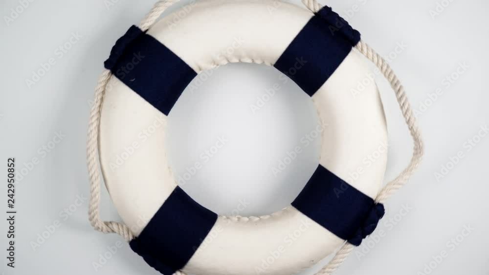 Life buoy ring lifebelt with rope rotating on white background. Top ...