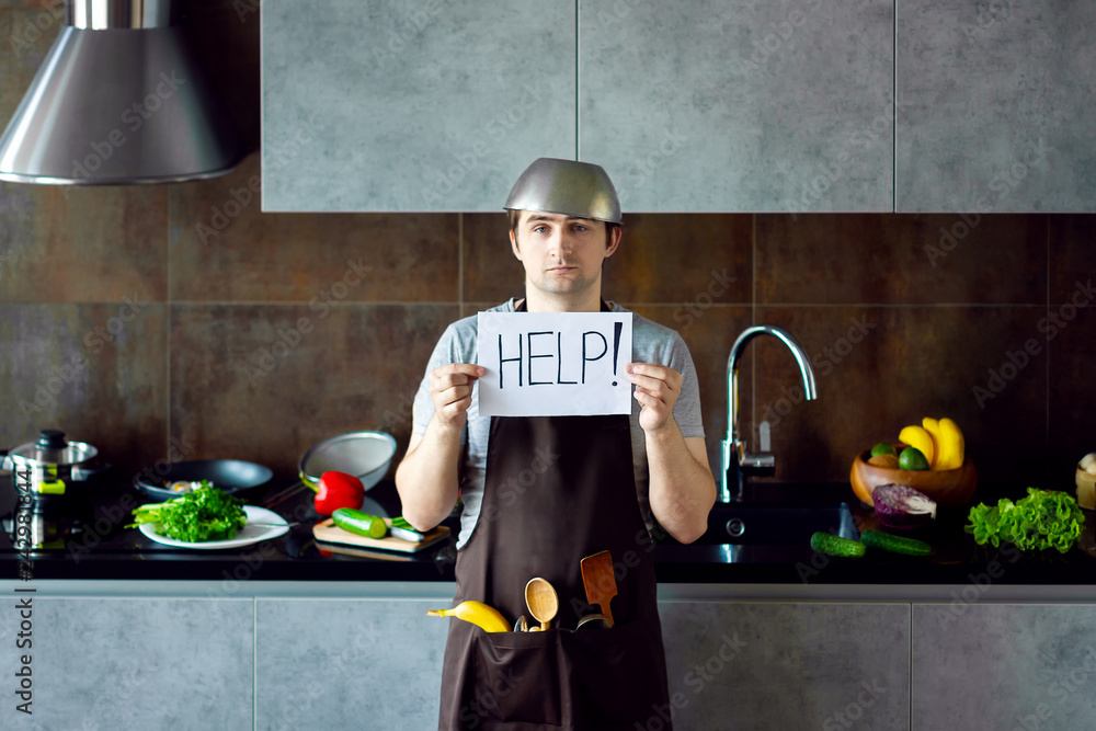 Funny loser man male guy with metal sieve, frying pan, wooden kitchen ...