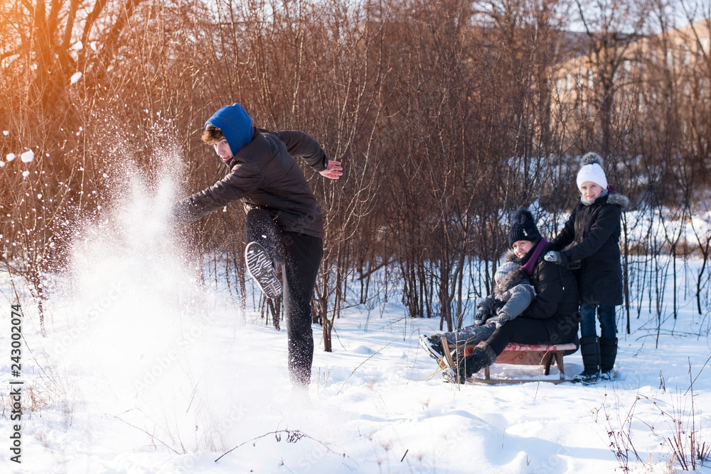 The family has fun together - they ride in sledges in winter in snow ...