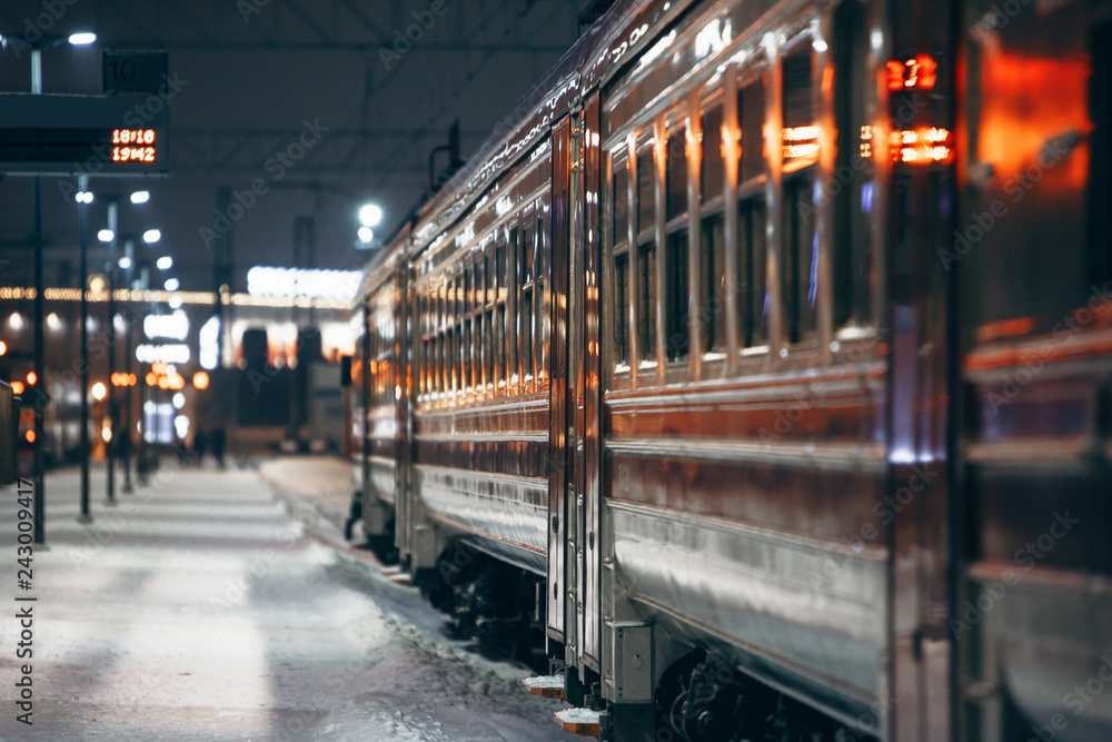 Train on railroad station during snowing at night. Train prepared for ...