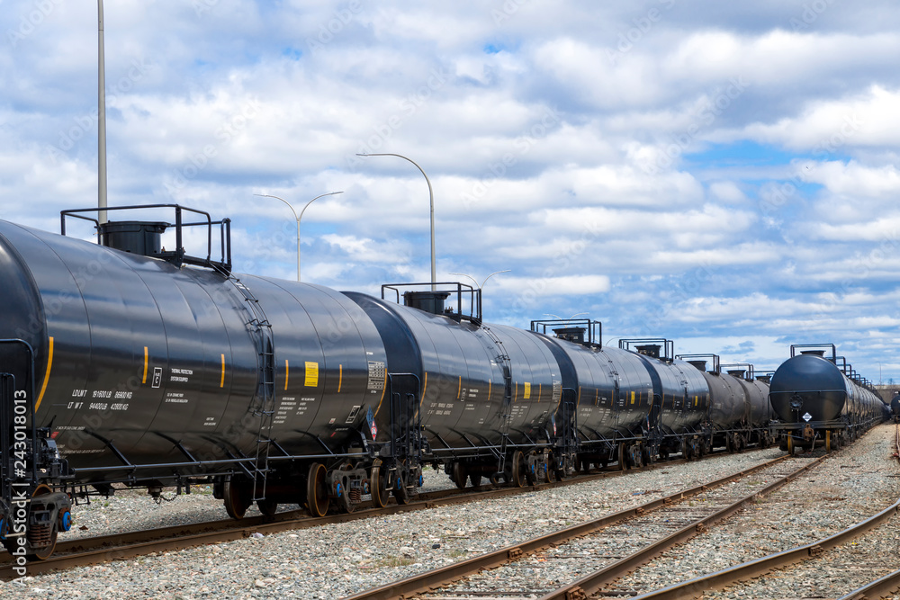 Black railway tanker cars of the type used to transport petroleum ...
