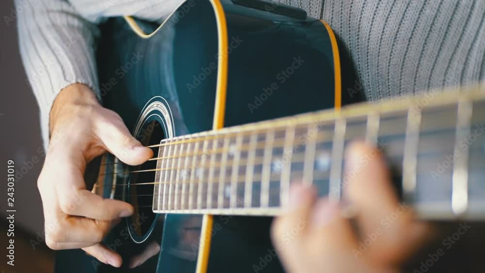 Man Playing an Acoustic Guitar. Slow movement of the vibrating string ...