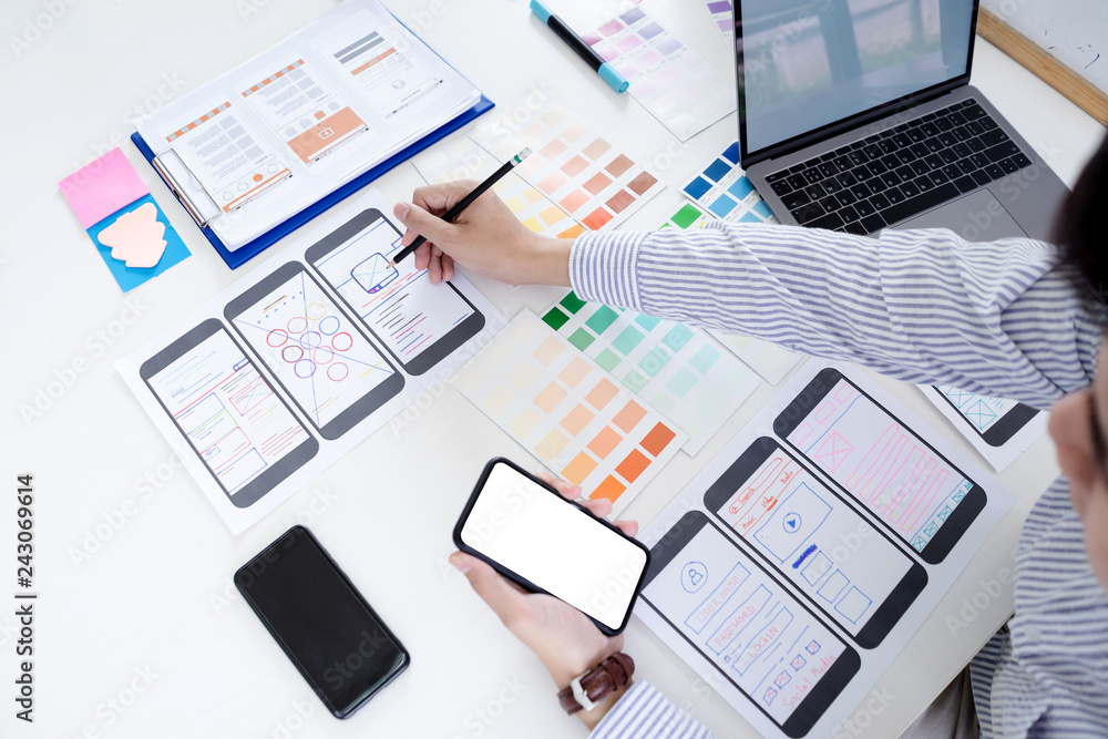 Hands sketching of screens for mobile responsive website development ...